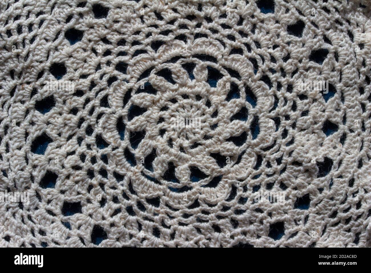 Full frame macro texture background of a white hand crocheted doily ...