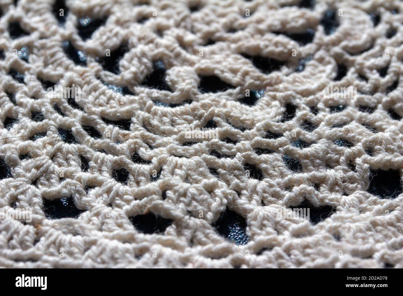Full frame macro texture background of a white hand crocheted doily ...