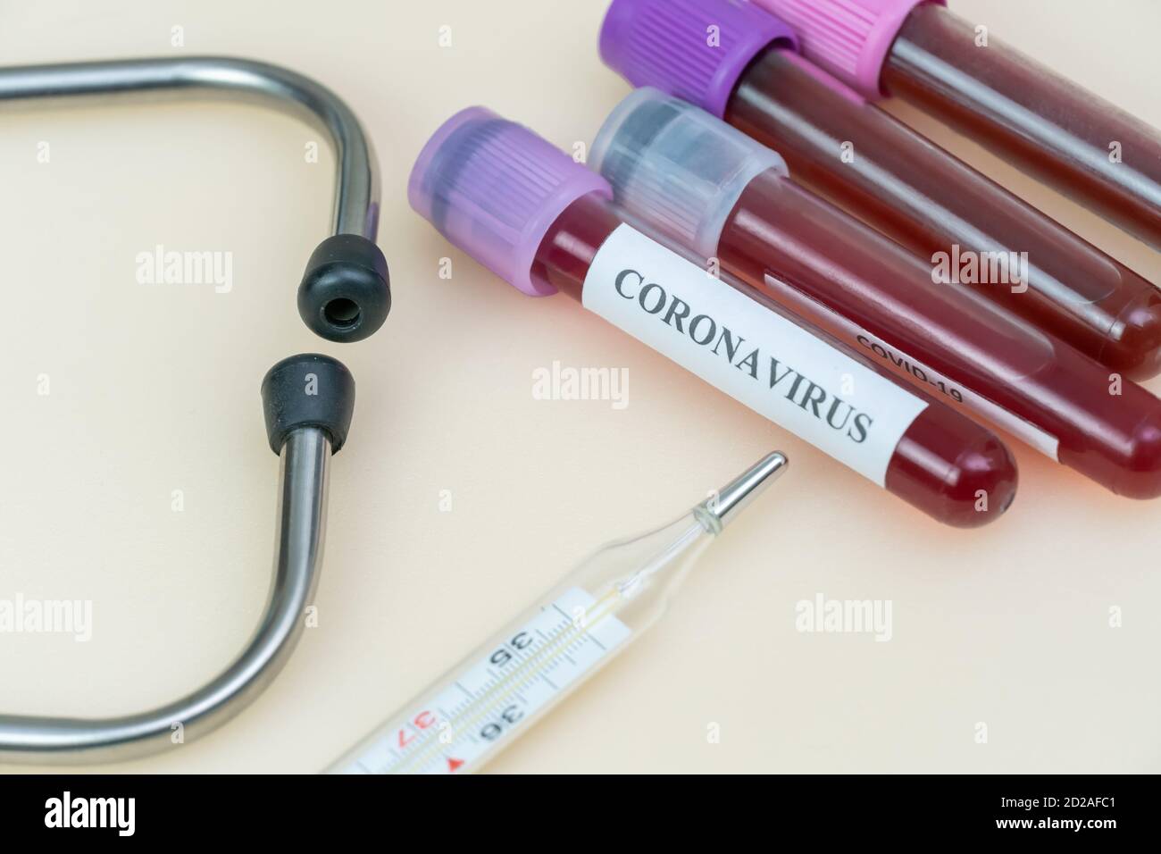 On the table are vials of blood with the words Coronavirus, stethoscope ...
