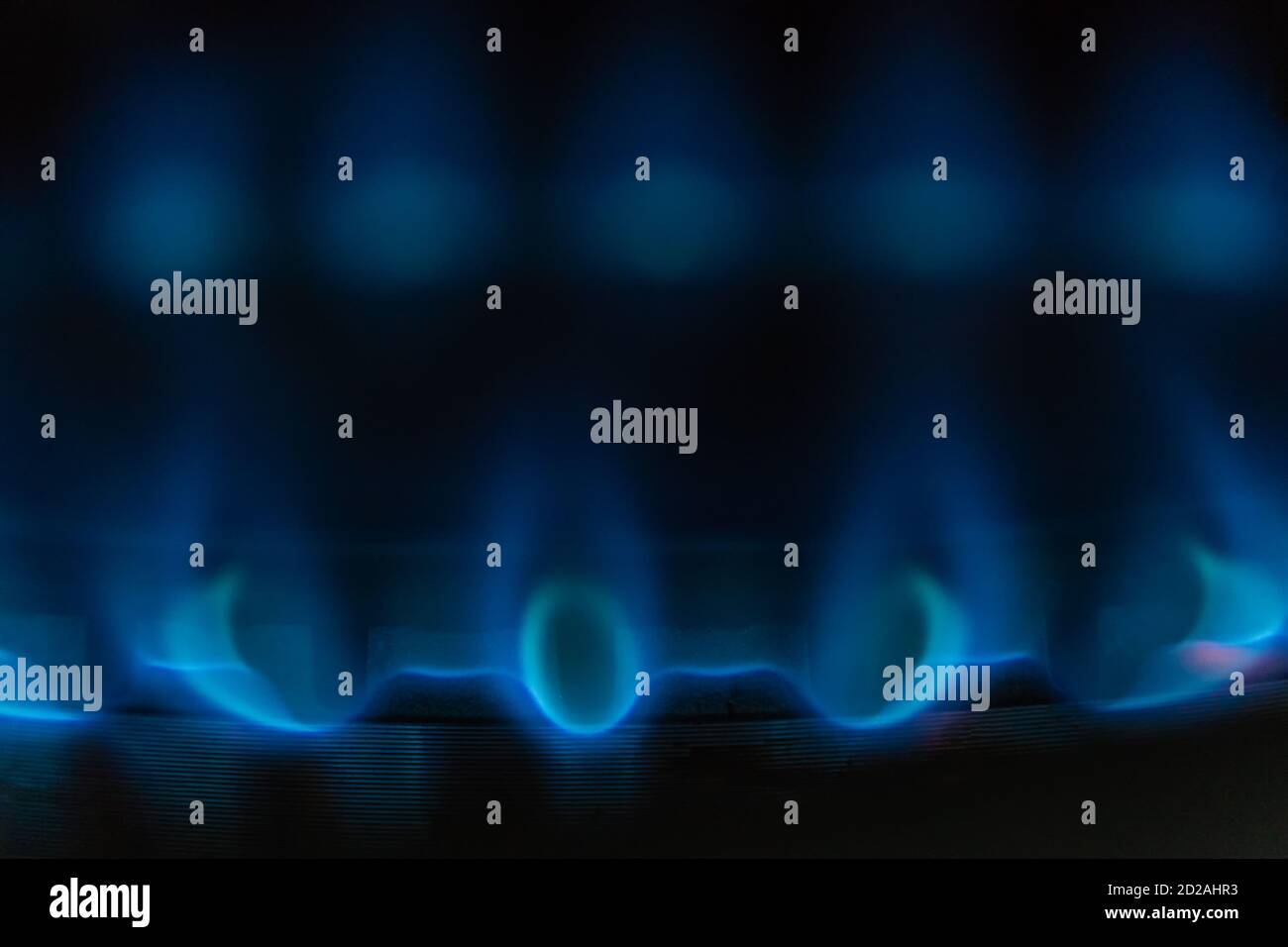 Blue flame of burning gas on a gas stove macro Stock Photo - Alamy