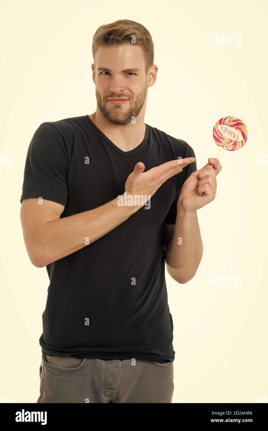 Candy made for love. Handsome guy show candy with love word lettering ...