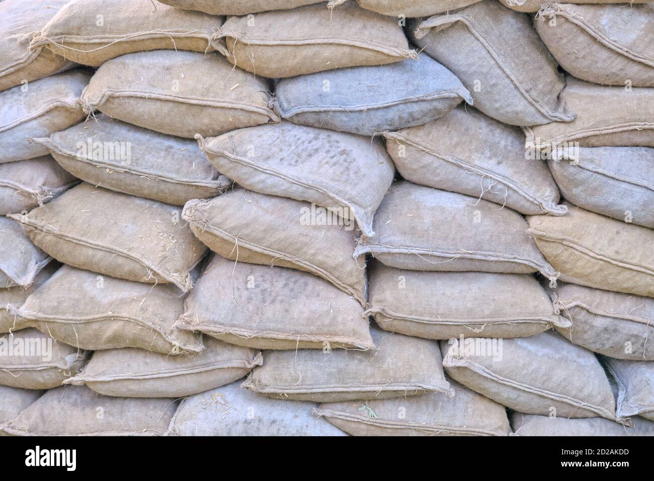 Background of full burlap dirty bags. Protective wall of sandbags ...