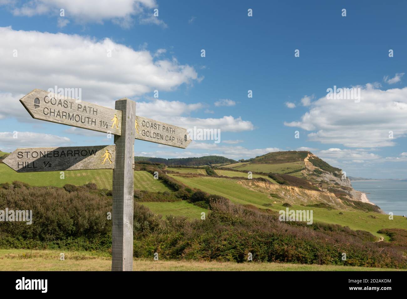 Close up of a sign post pointing toward Golden Cap mountain with Golden ...