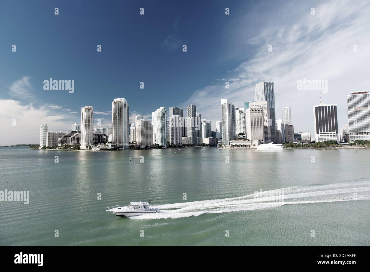 Aerial view of Miami skyscrapers with blue cloudy sky,white boat ...
