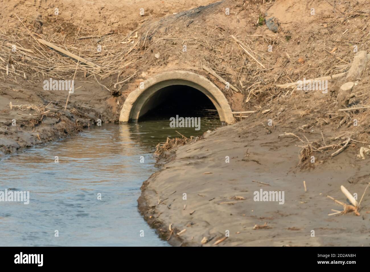 Drainage system under the highway. Concrete pipe under the road. River ...
