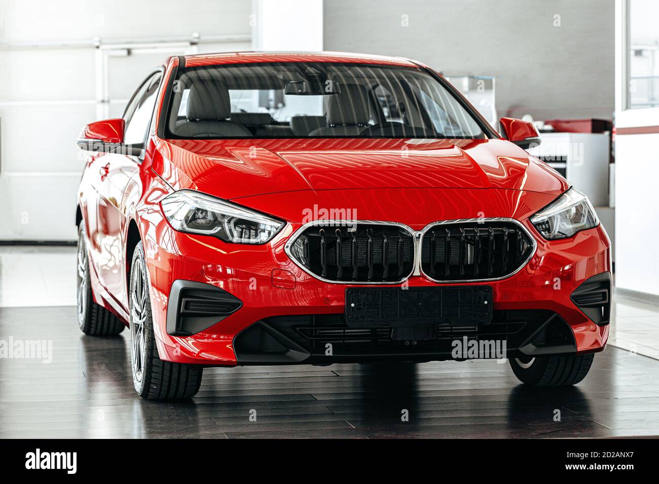 New red luxury car on a car presentation in showroom Stock Photo - Alamy