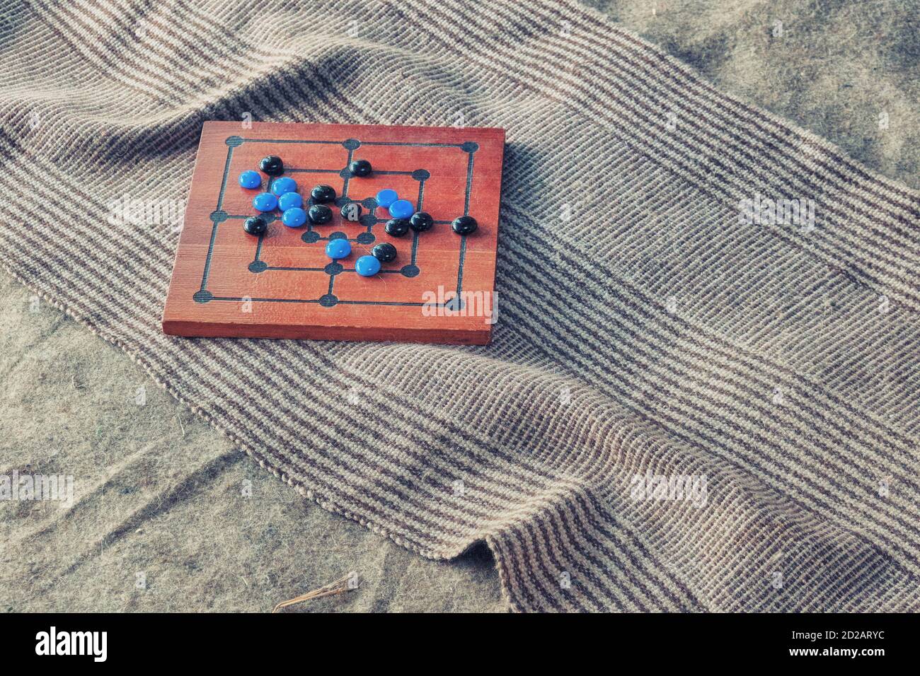 Board for the game of the mill with the placed chips. Board game with a ...