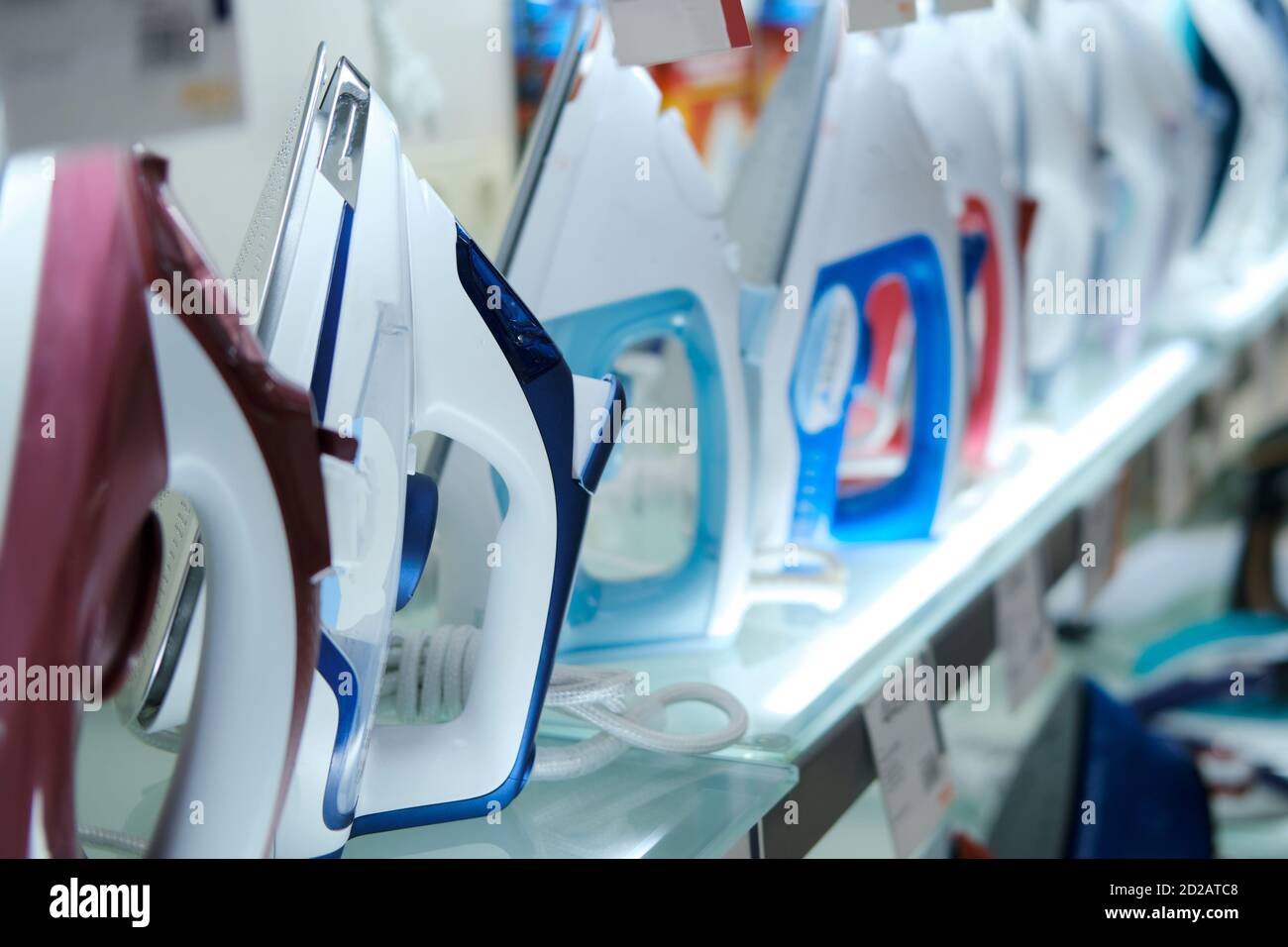 Electric iron on shelf rack display in the store Stock Photo - Alamy