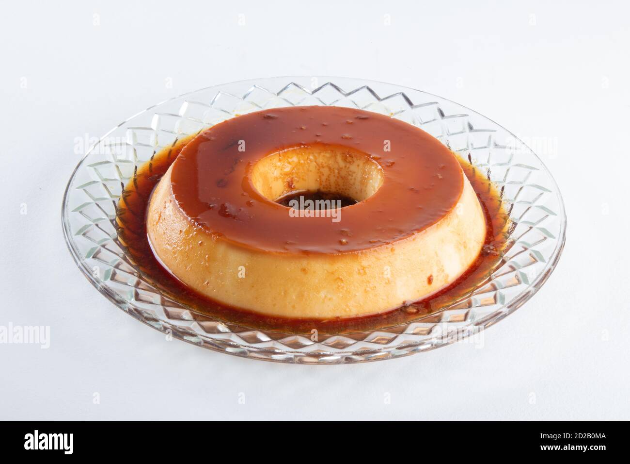 Delicious condensed milk pudding. Brazilian dessert. White background ...
