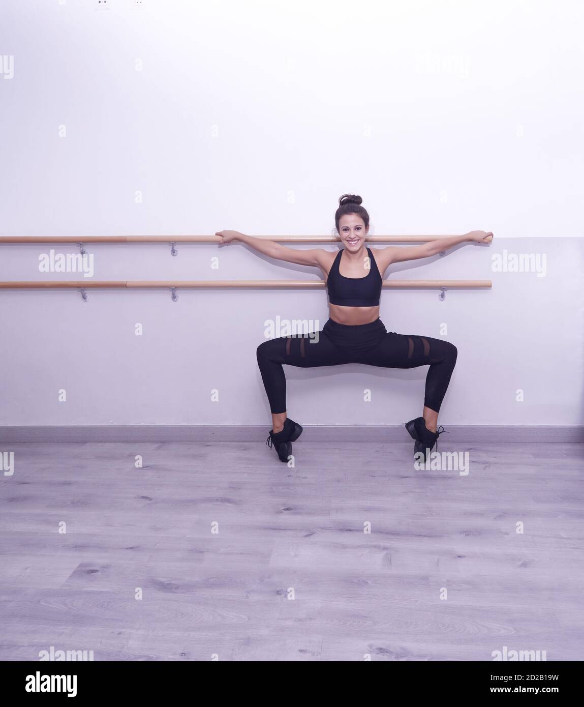 Young Caucasian woman practicing gymnastics and stretching Stock Photo ...
