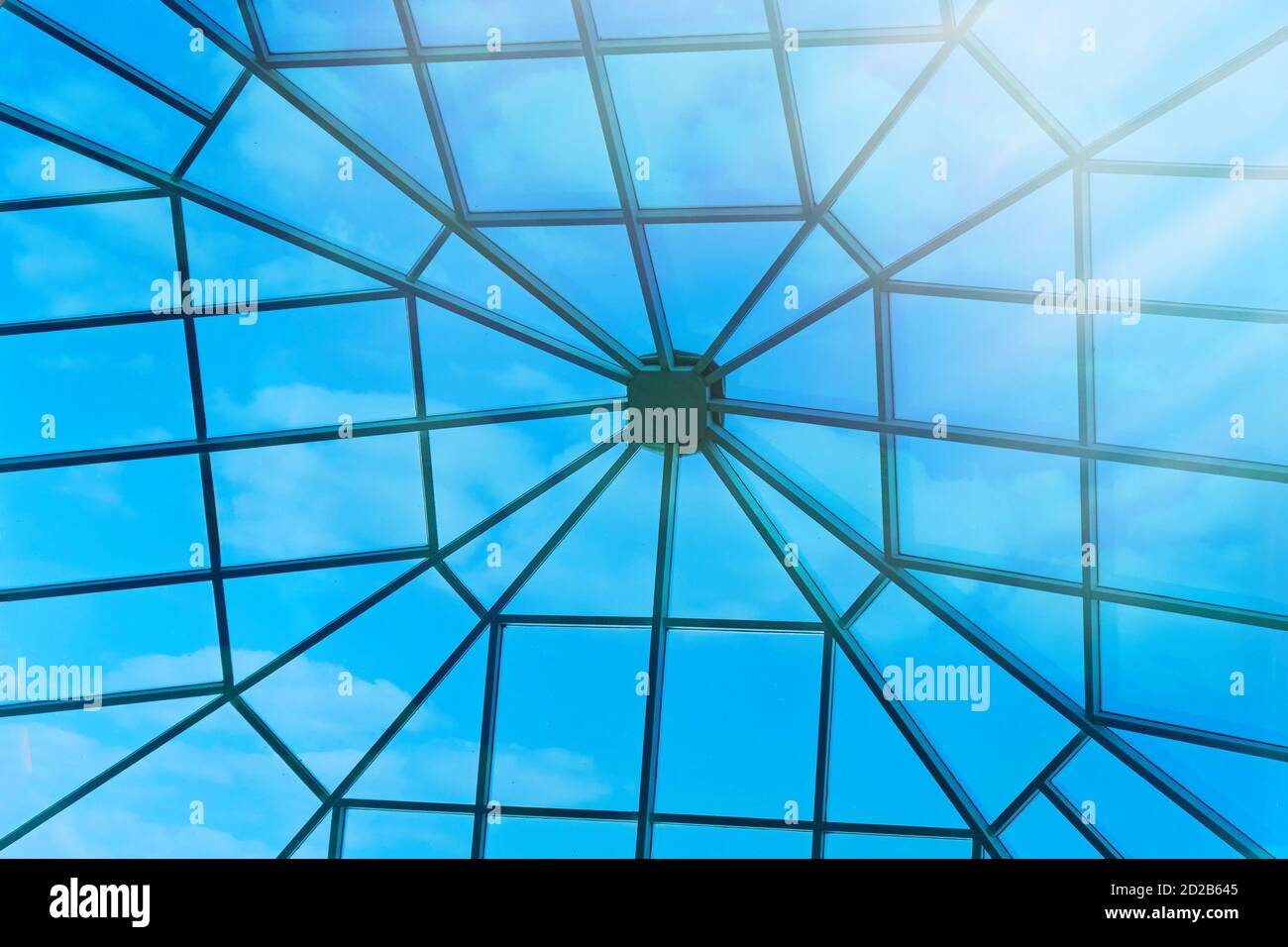 Clouds through the glass window at the top of the building. Sky and ...