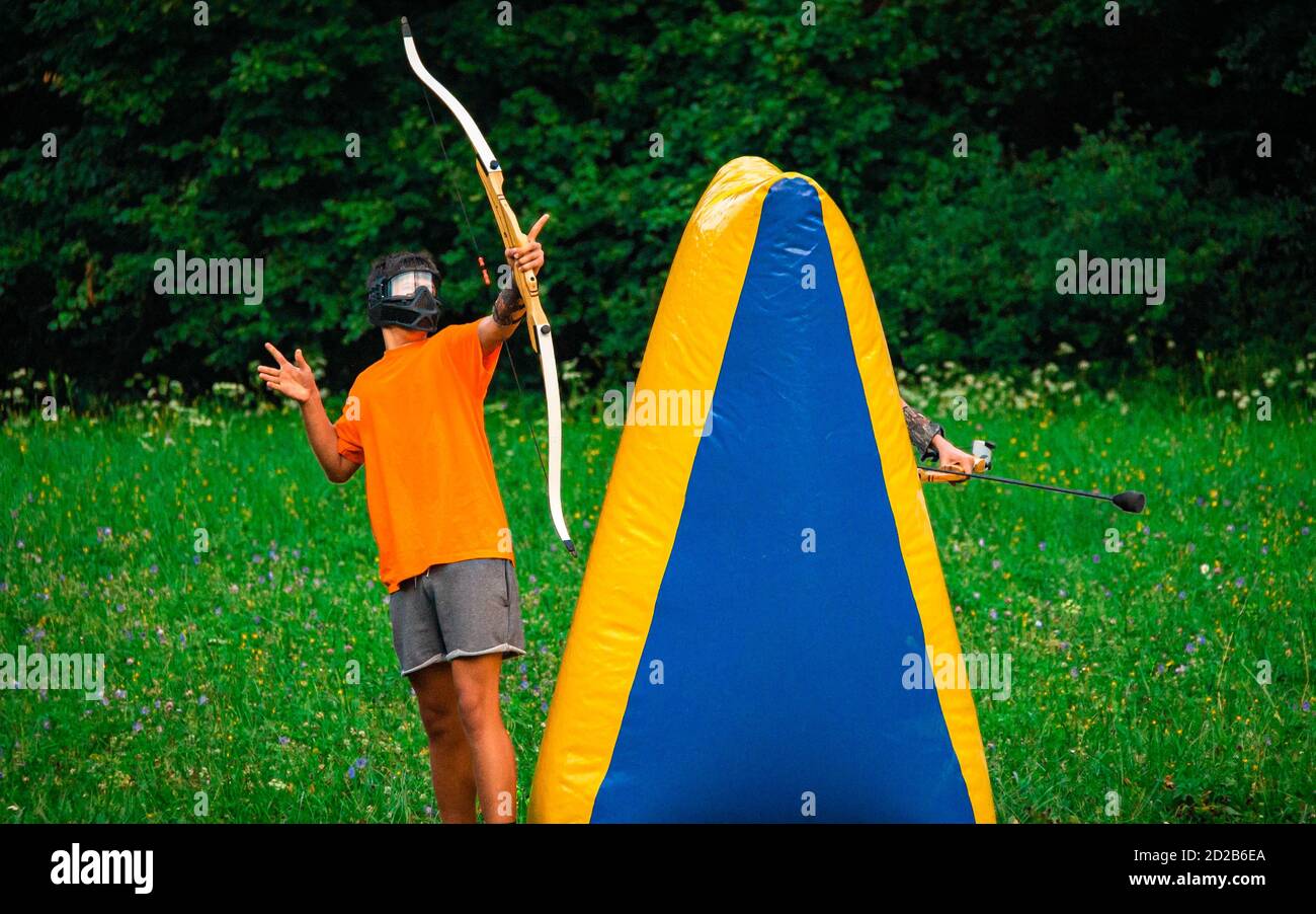 A boy has just shot an arrow from a bow Stock Photo - Alamy