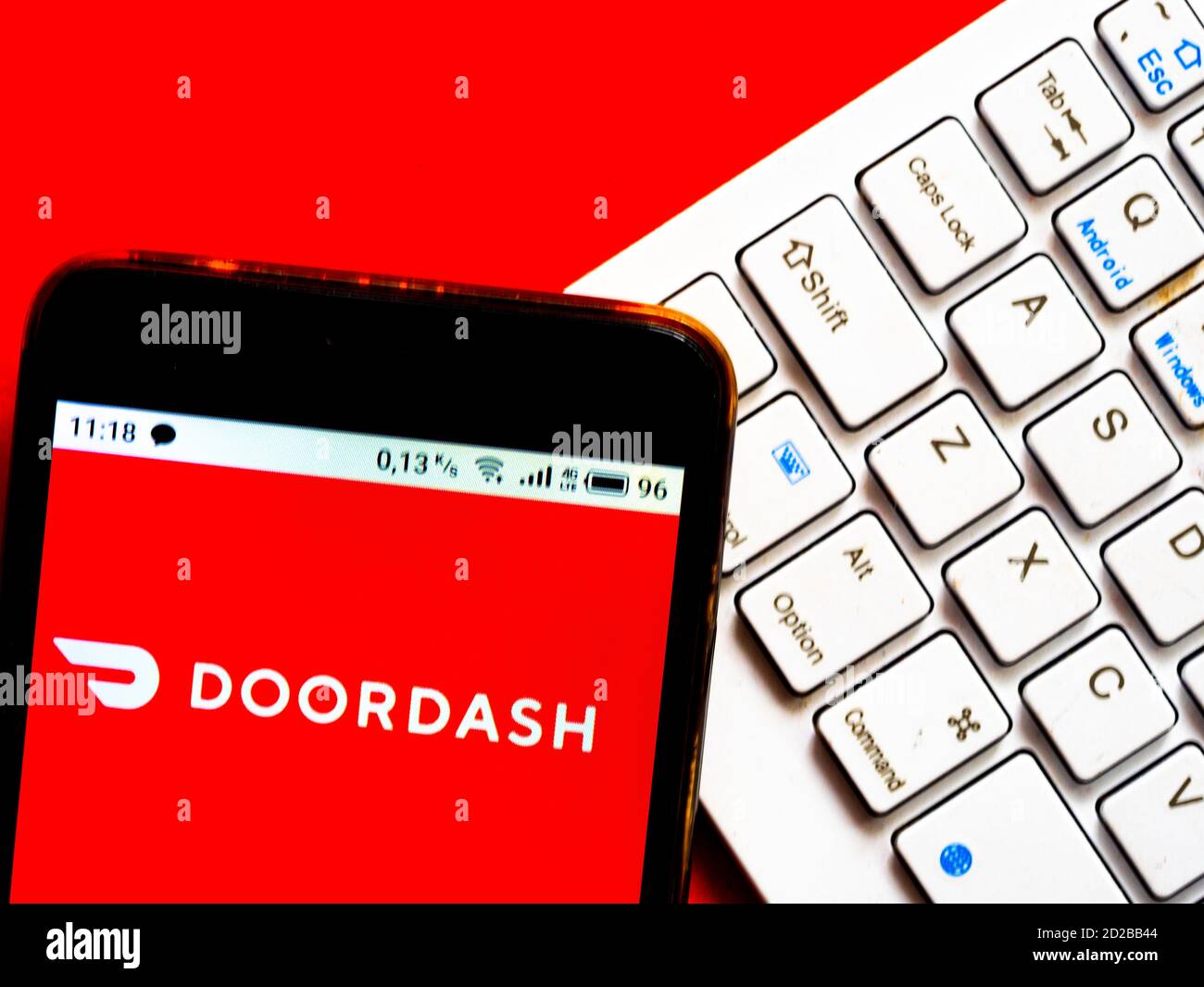 In this photo illustration a DoorDash Inc. logo seen displayed on a ...