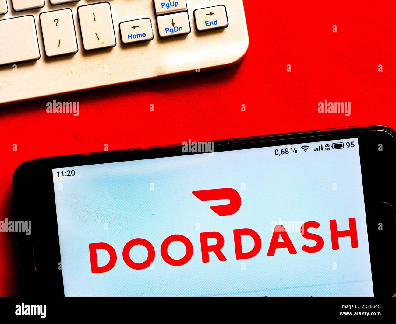 In this photo illustration a DoorDash Inc. logo seen displayed on a ...