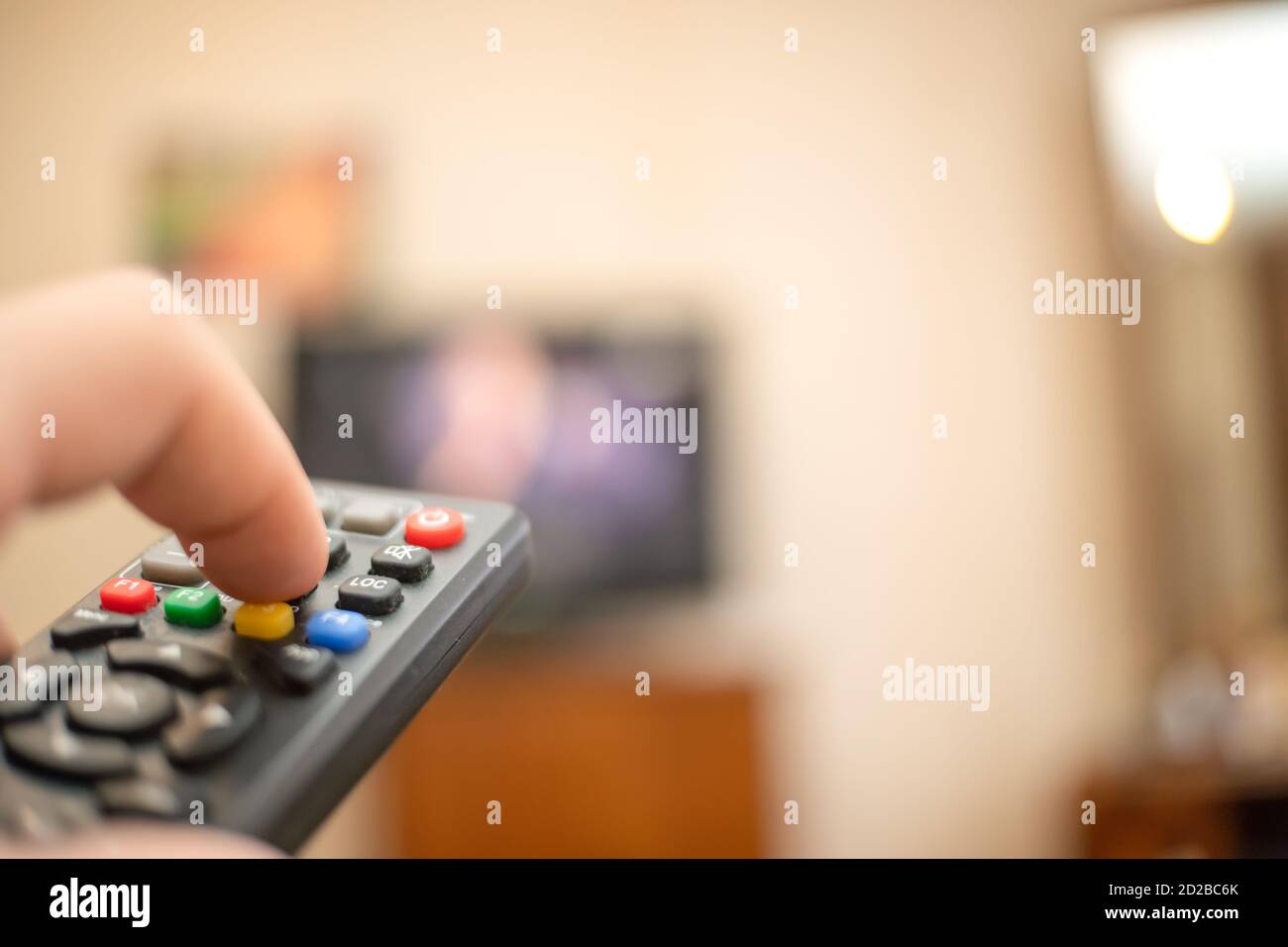 Mans hand television remote control hi-res stock photography and images ...