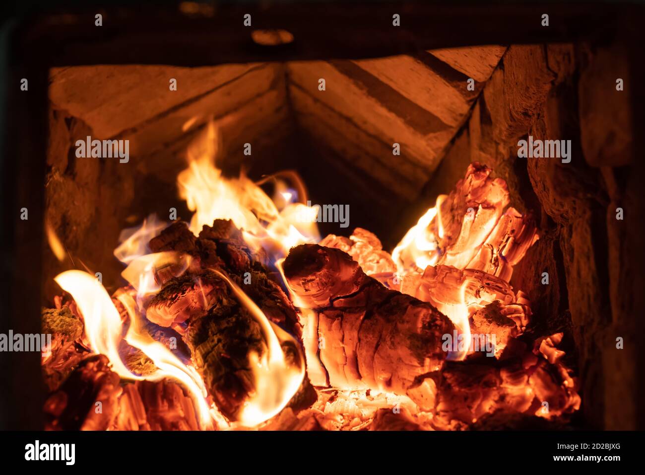Close-up of burning wood in the stove, fireplace. The concept of ...