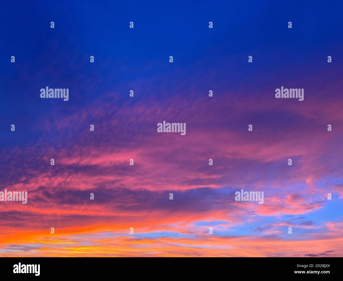 Beautiful pink, orange and blue sunset reflecting on a lake in a ...