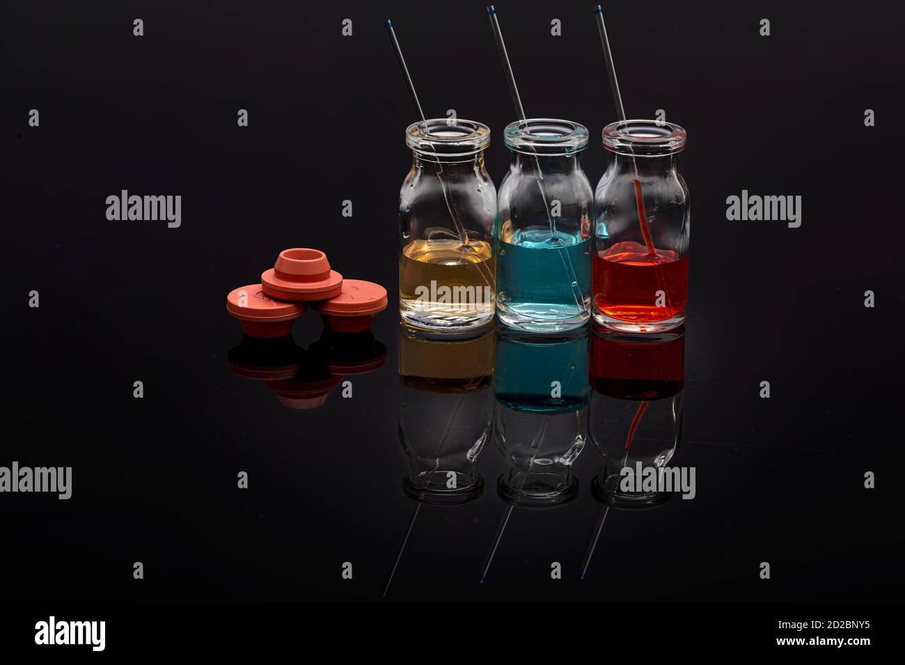 Glass vials with colored medicine liquid with capillaries. Red, yellow ...