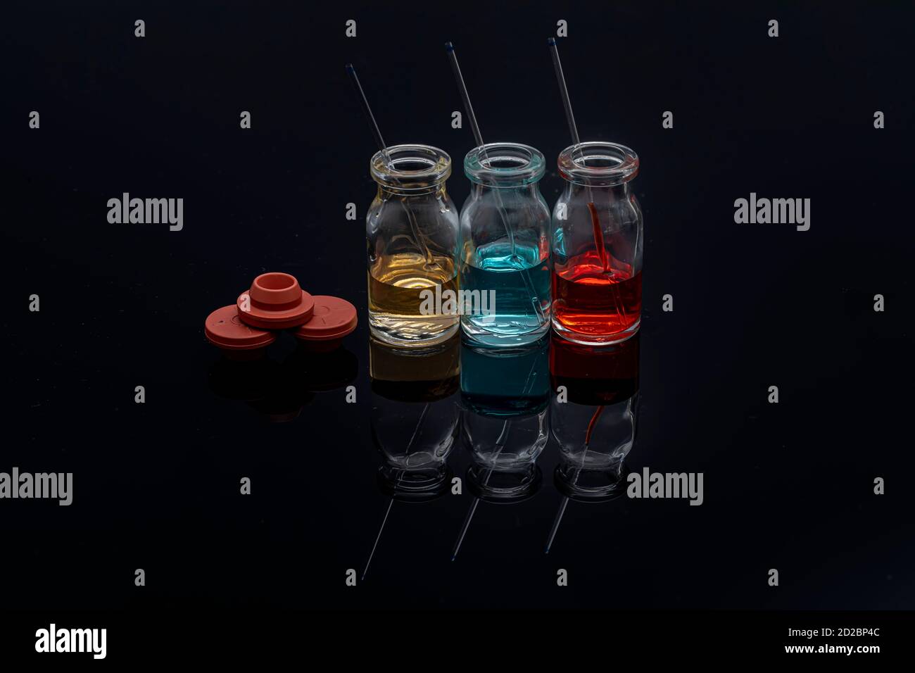 Glass vials with colored medicine liquid with capillaries. Red, yellow ...