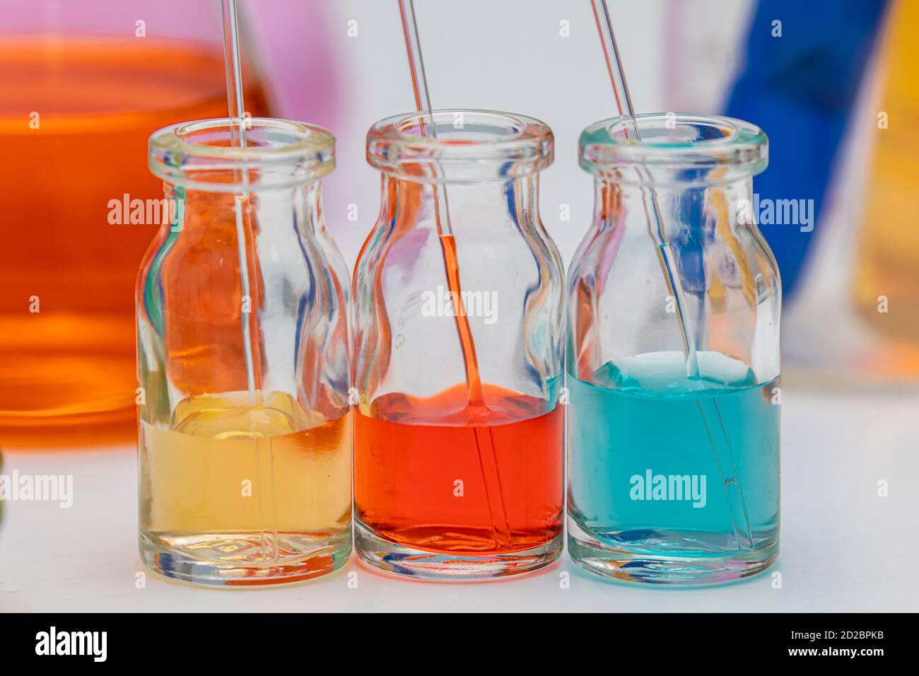 Glass vials with colored medicine liquid with capillaries. Red, yellow ...
