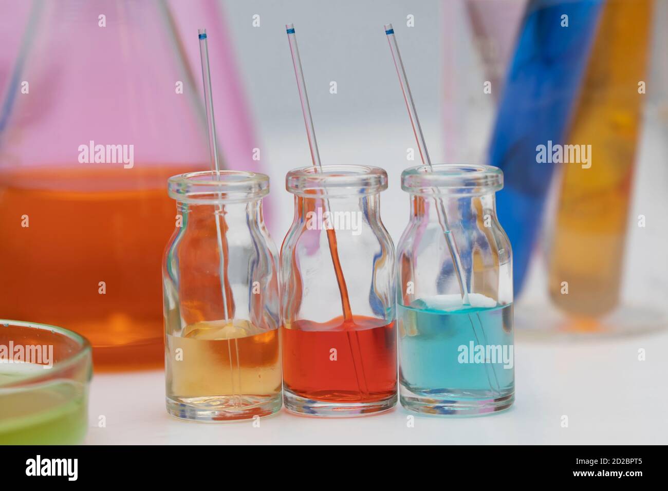 Glass vials with colored medicine liquid with capillaries. Red, yellow ...
