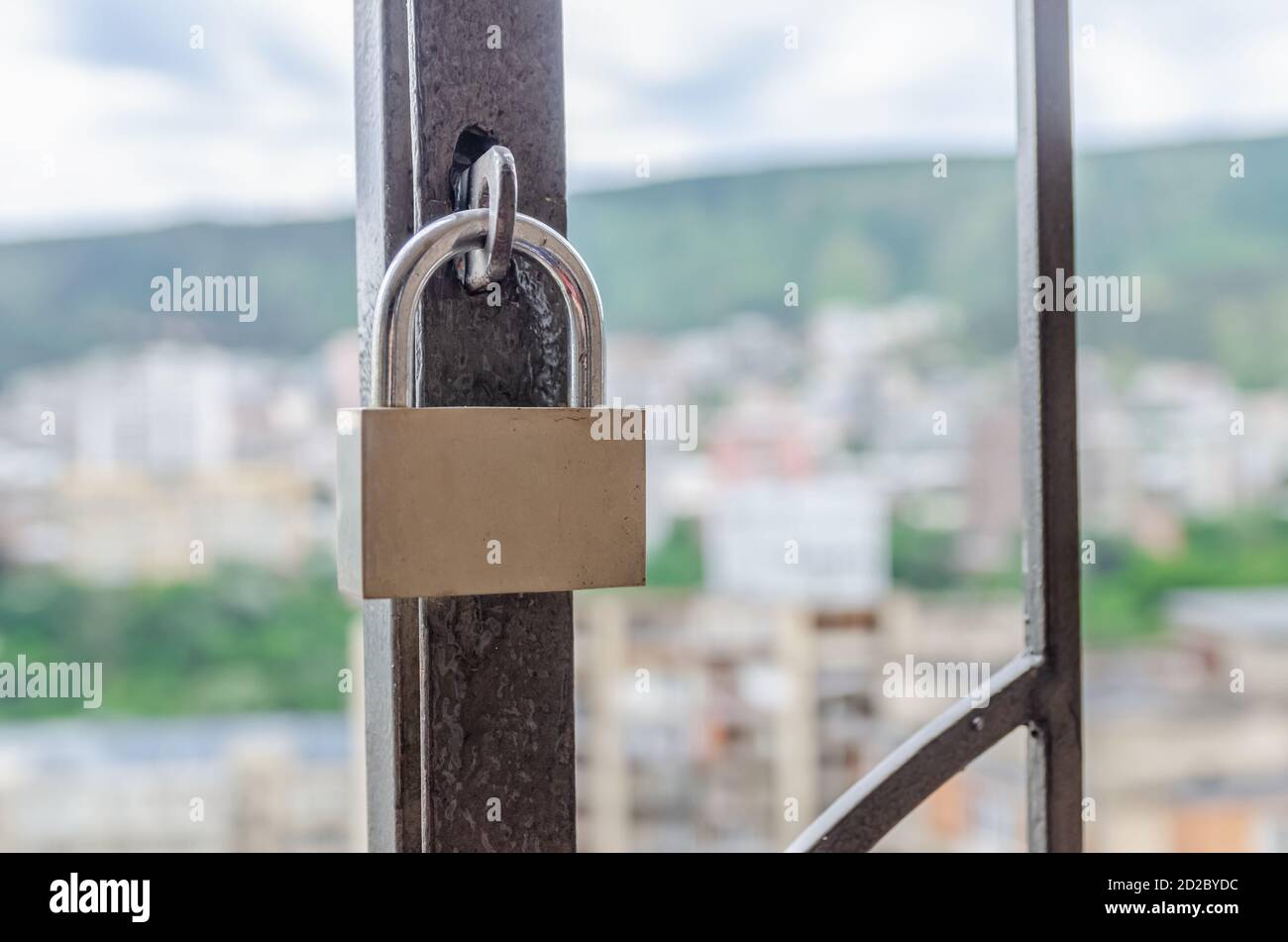 Metal lock on the bars of the window close-up, the last floor. Security ...