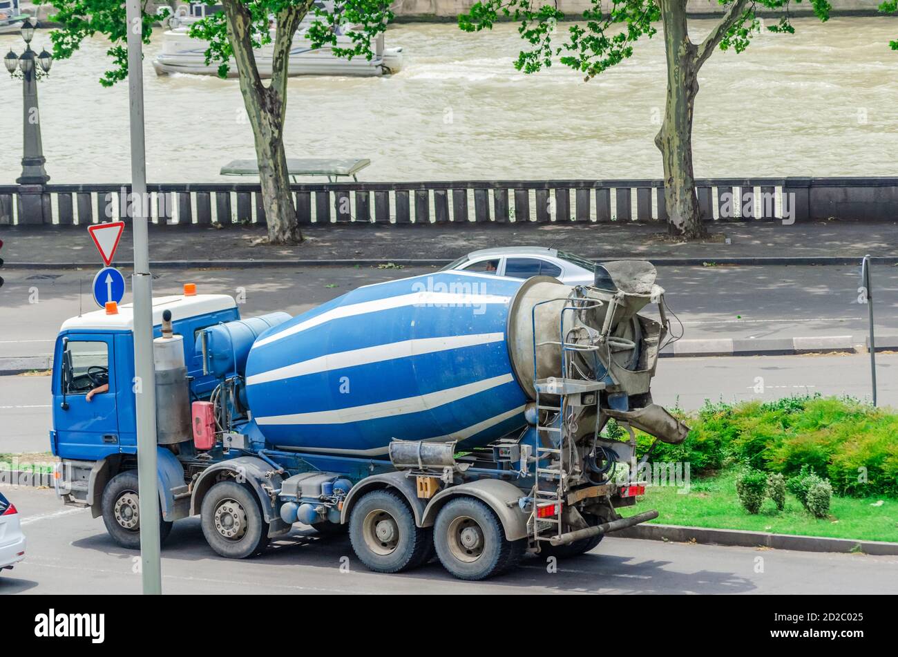 The blue-white cement truck moves through the city streets, Tbilisi ...