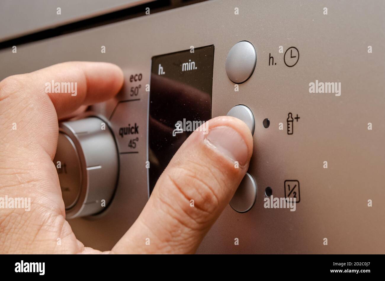 man's hand sets in stylish black dishwasher control panel Stock Photo ...
