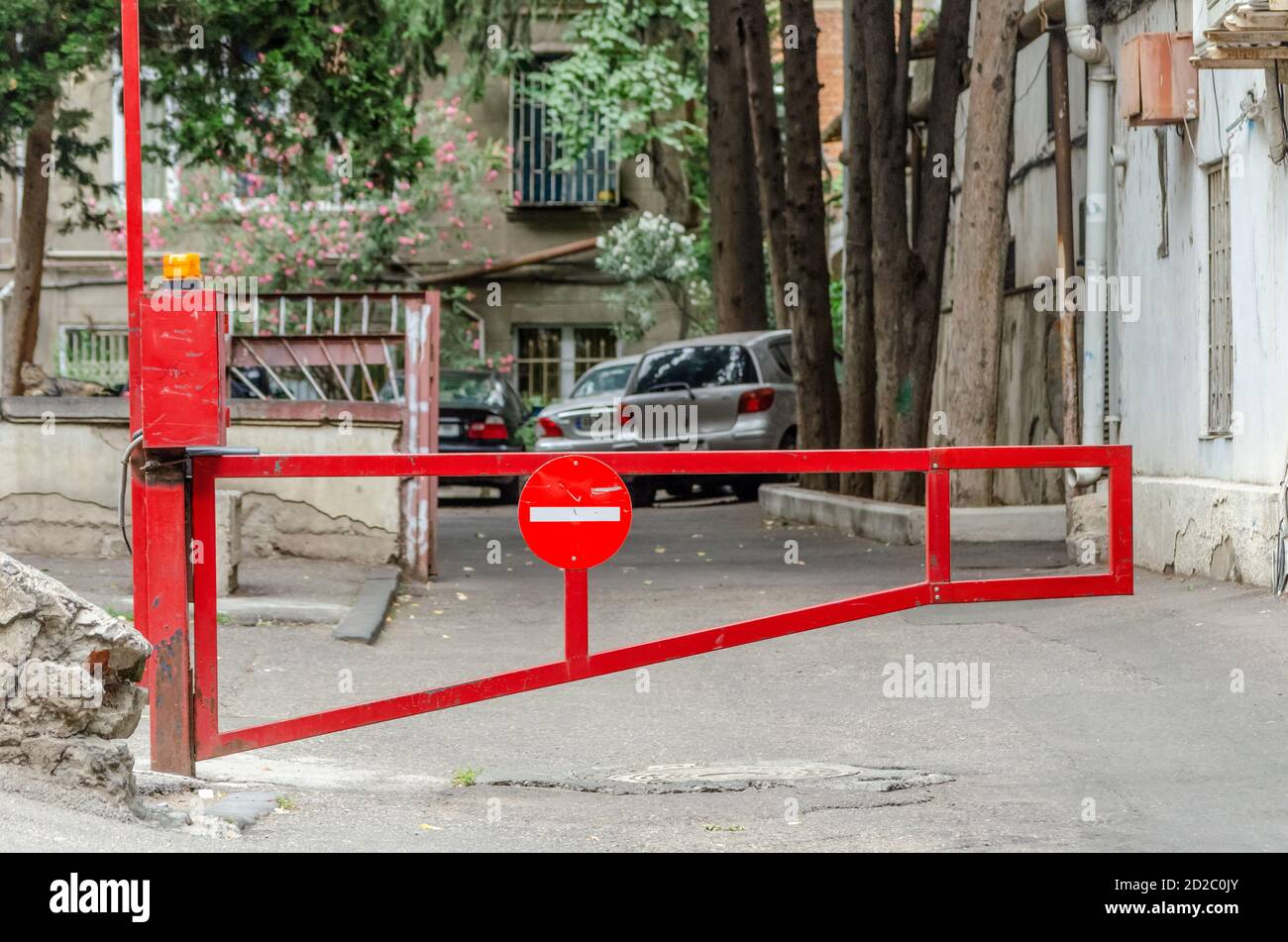 Red barrier with a road sign travel is prohibited in the residential ...