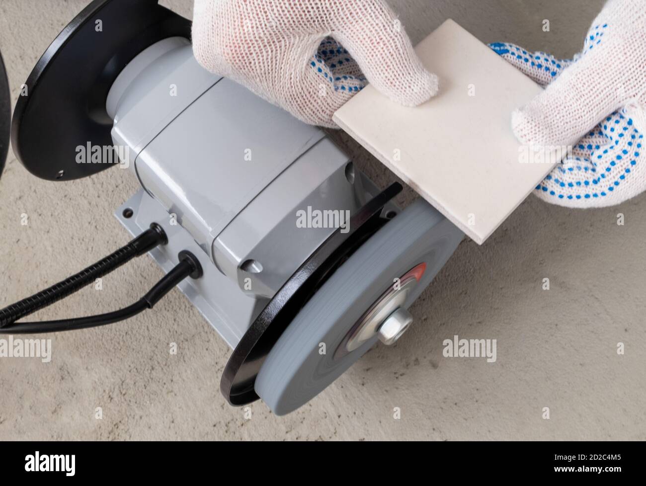 Processing tile or porcelain tiles with a grinder Stock Photo - Alamy