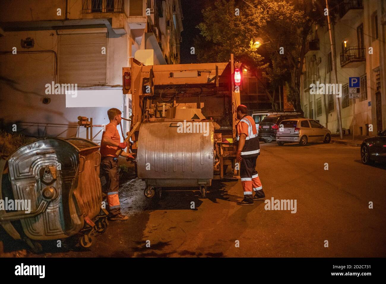 Tbilisi, Georgia - June 27 2019: Two workers in the orange garbage ...