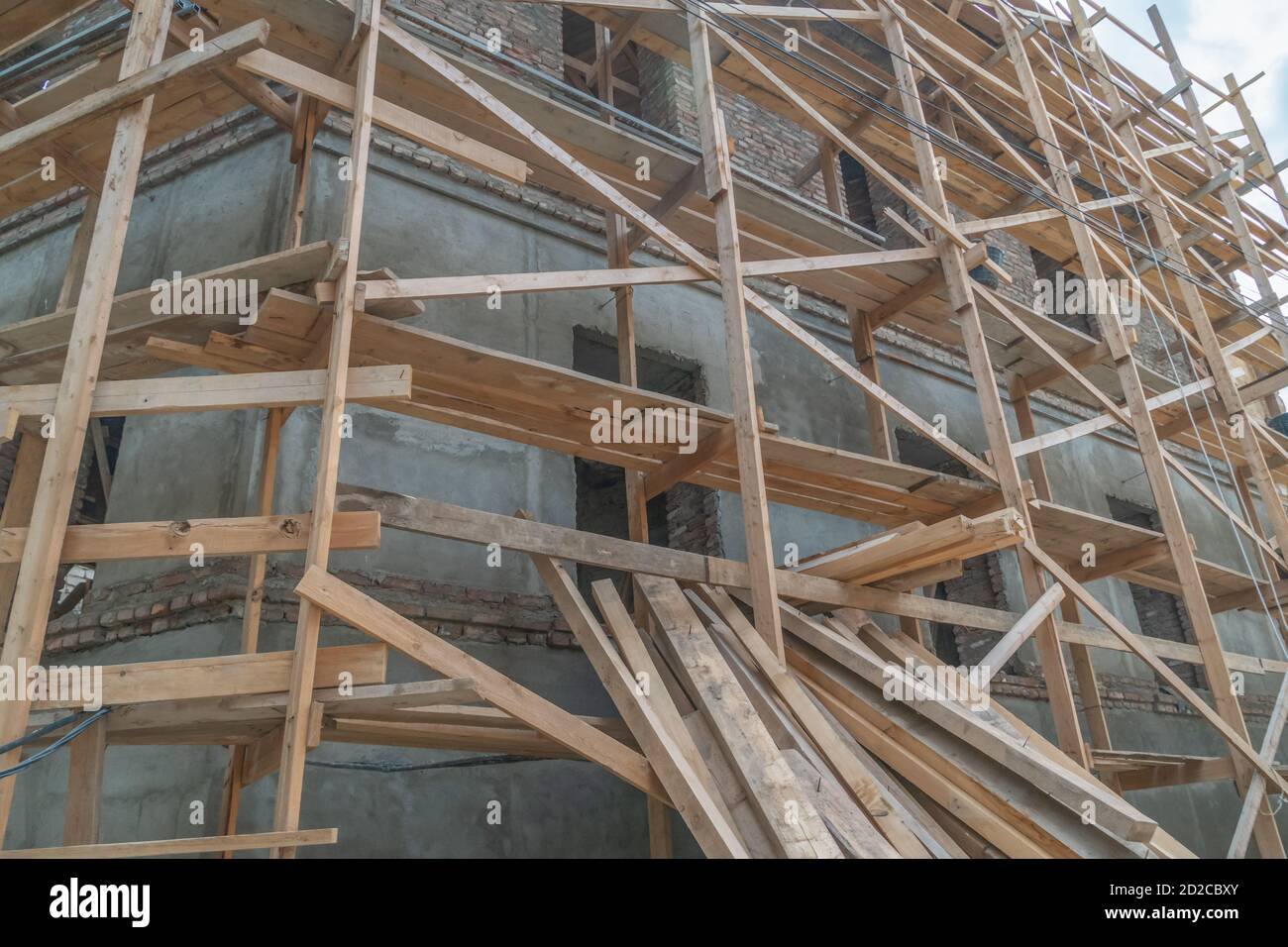 Home construction. Wooden scaffolding on a building close up Stock ...