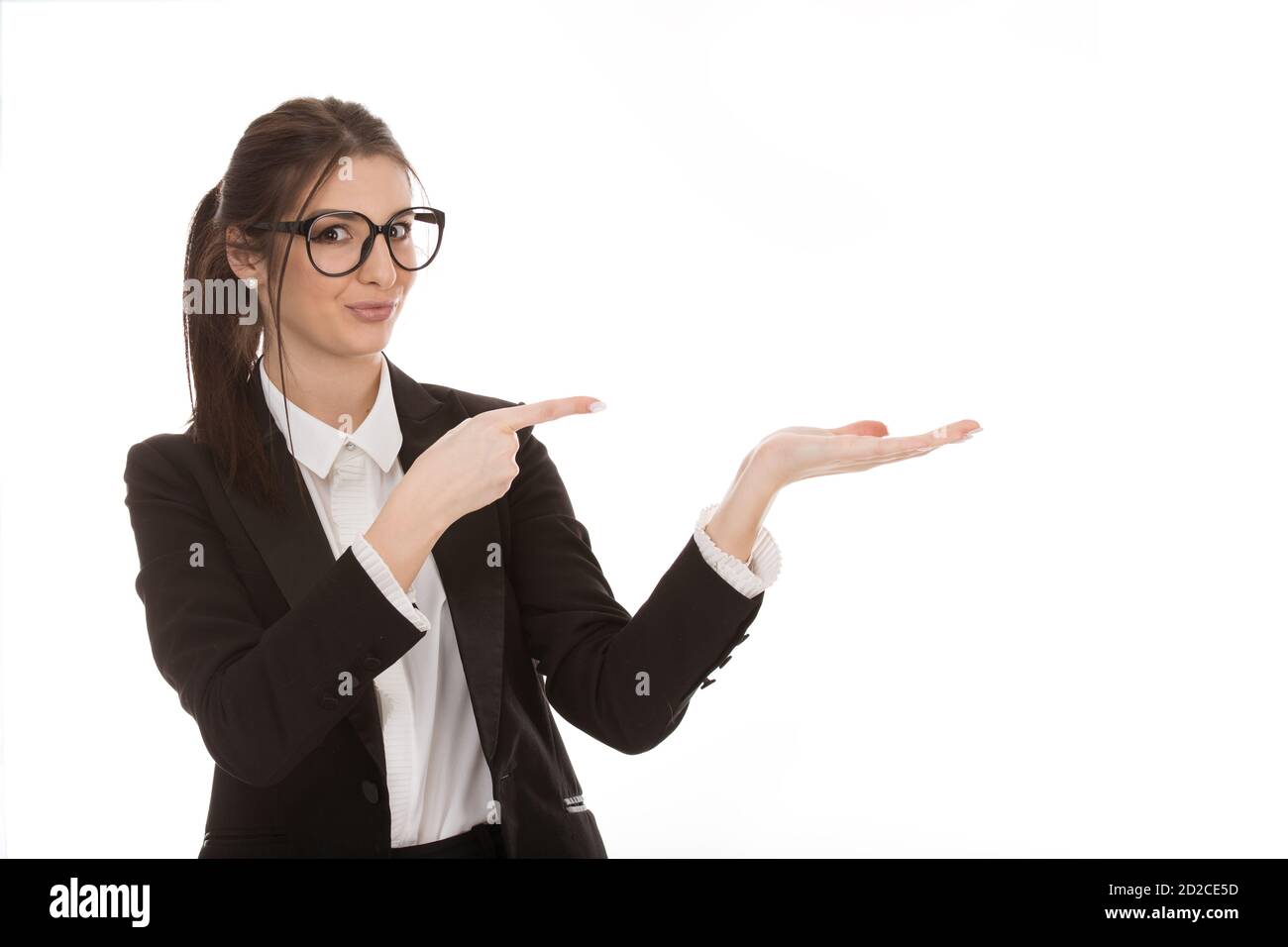 Closeup portrait of a beautiful happy woman pointing with index finger ...