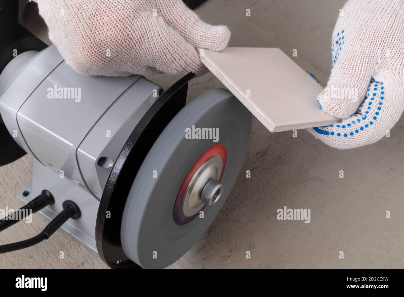 Processing tile or porcelain tiles with a grinder Stock Photo - Alamy