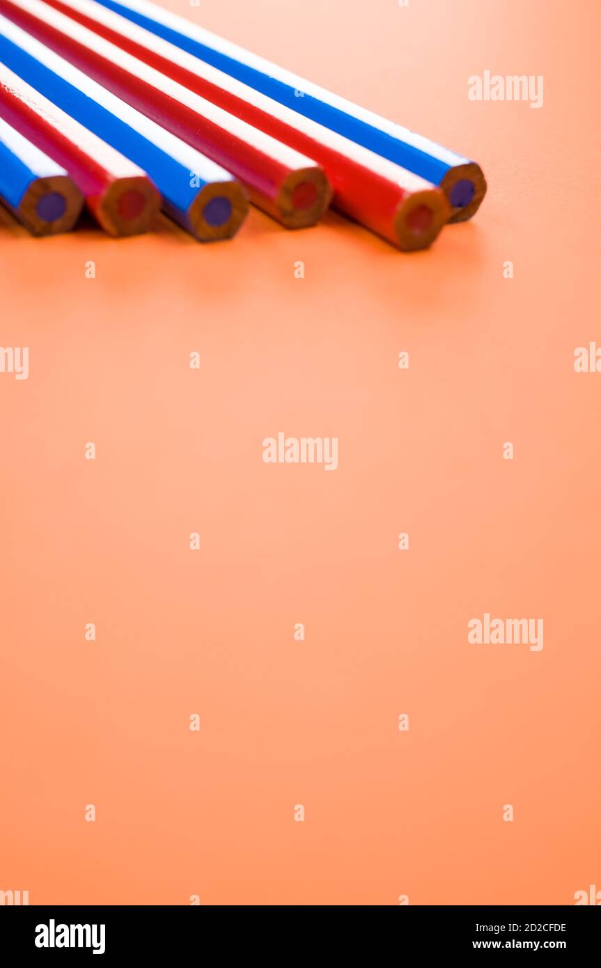 Vertical shot of red and blue pencils on a pink surface Stock Photo - Alamy