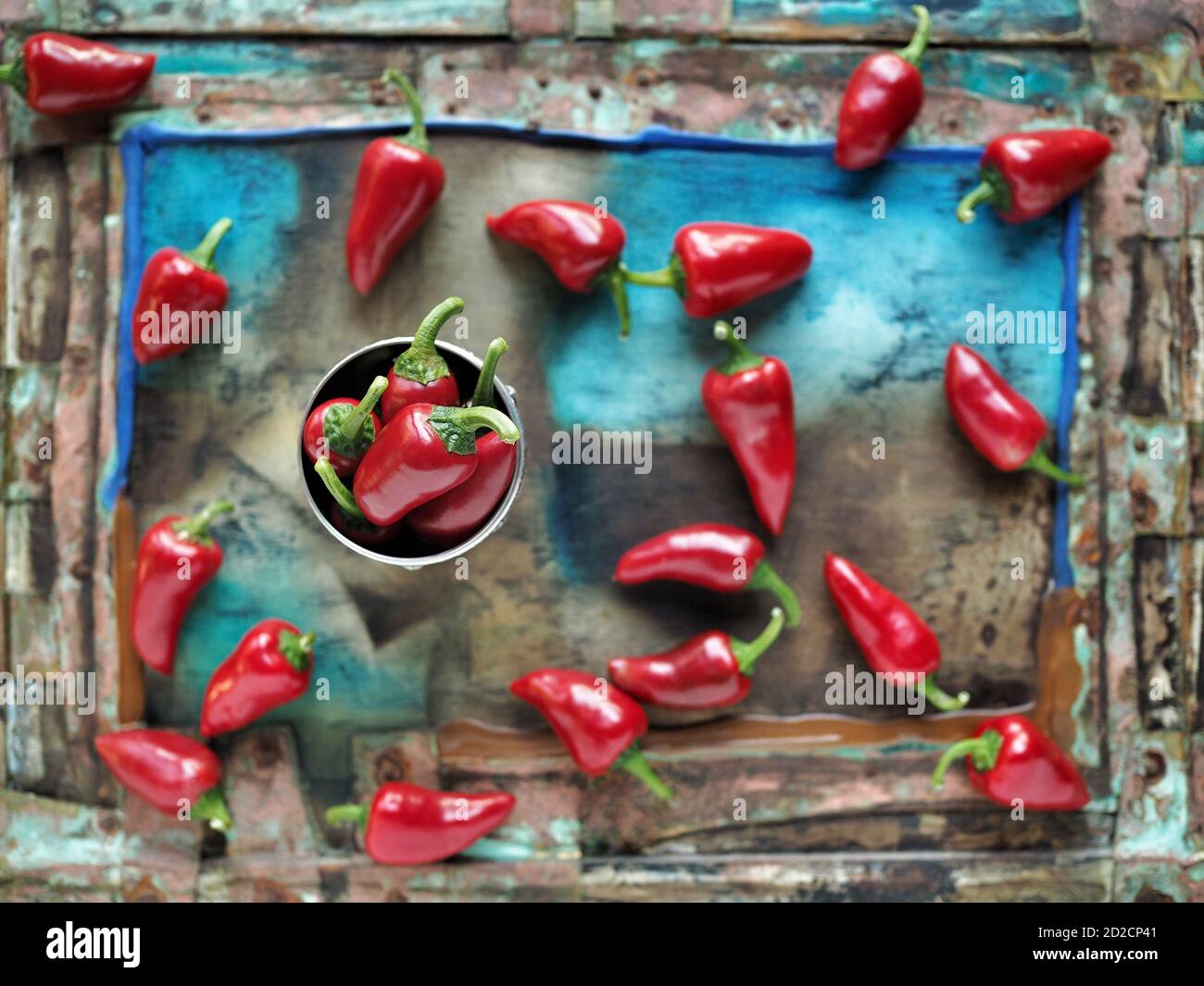 Chilli peppers on old vintage color table withe frame. Overhead shot ...