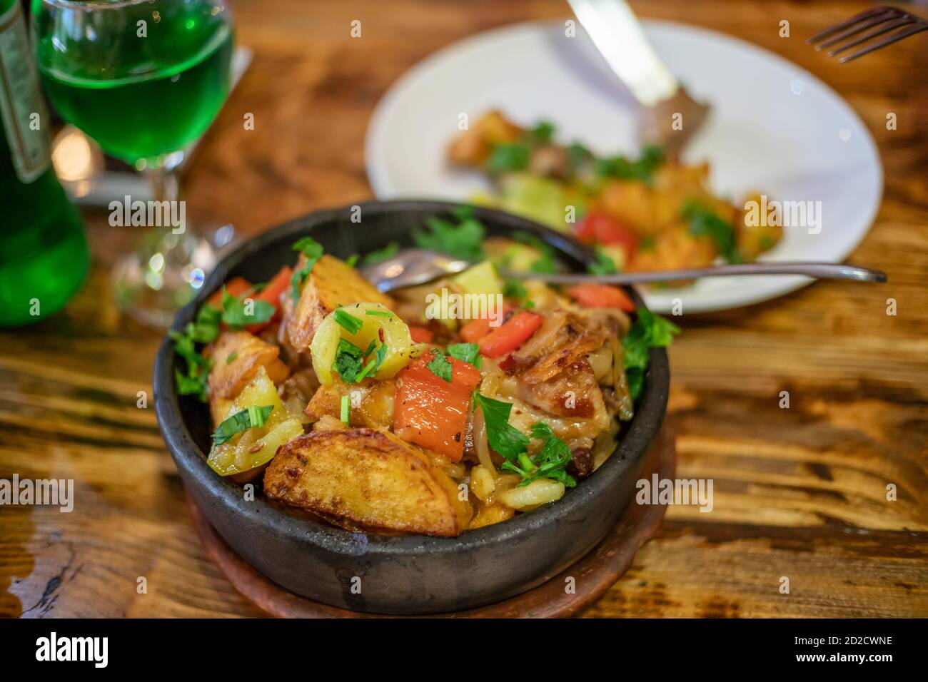 Traditional Georgian family food ojakhuri, fried meat with potatoes and ...