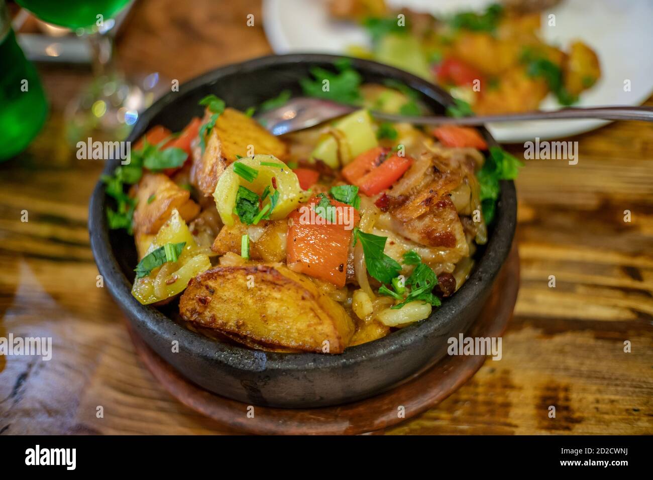 Traditional Georgian family food ojakhuri, fried meat with potatoes and ...