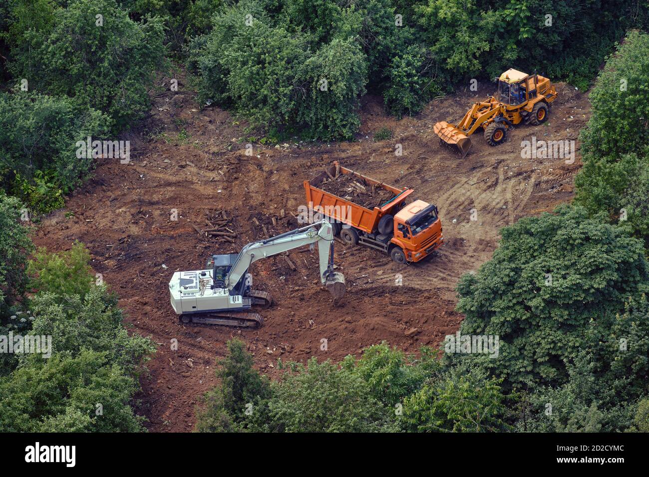 Bulldozers, excavators and a truck in the forest, top view Stock Photo ...