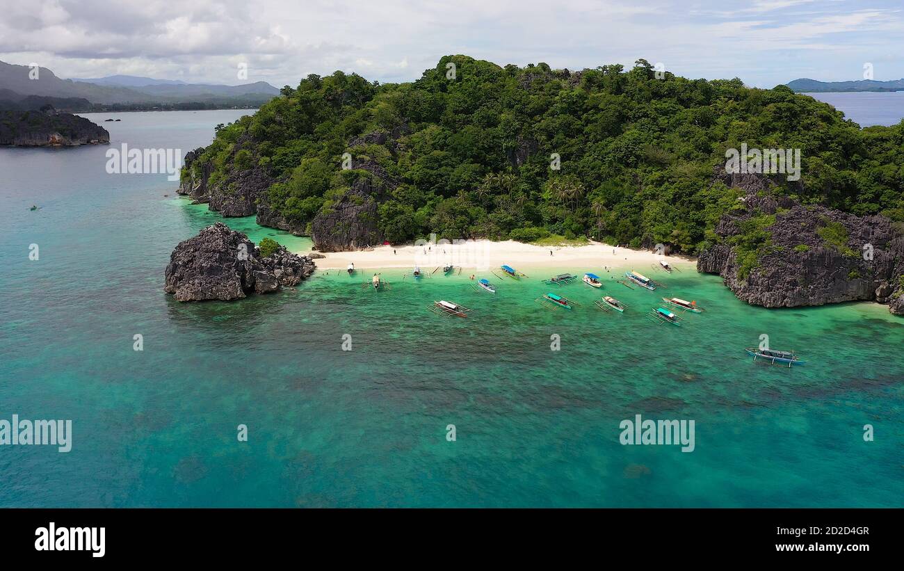 Tropical landscape: Lahos Island with beautiful beach and tourists by ...
