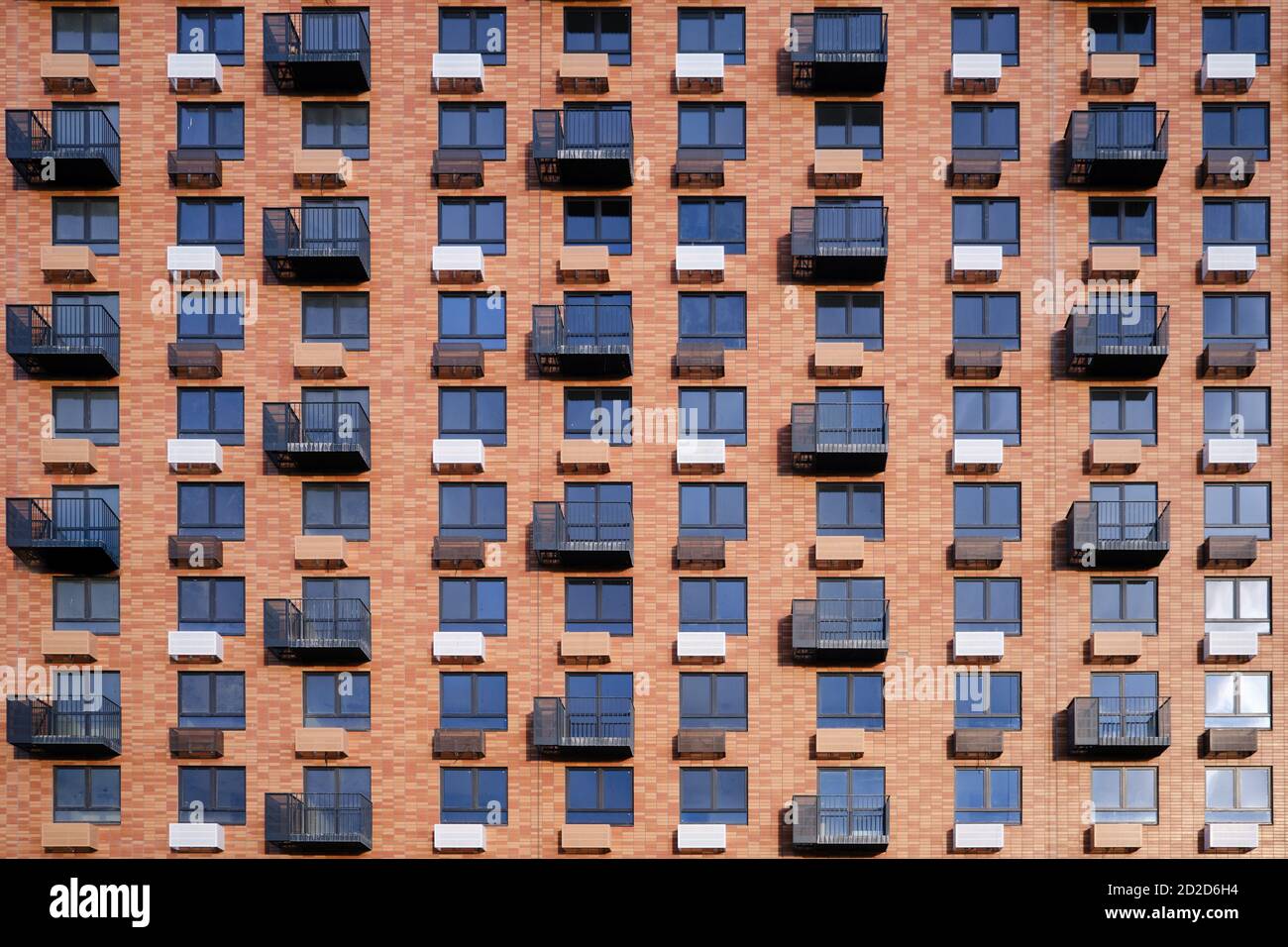 The facade of the building with a brown wall, balconies and niches for ...
