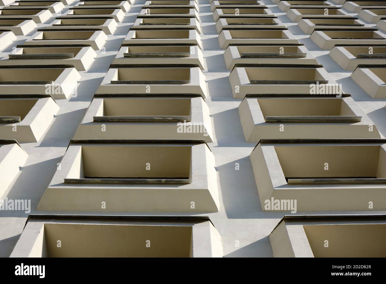 Convex windows of a white building in regular rows. Unusual bottom view ...