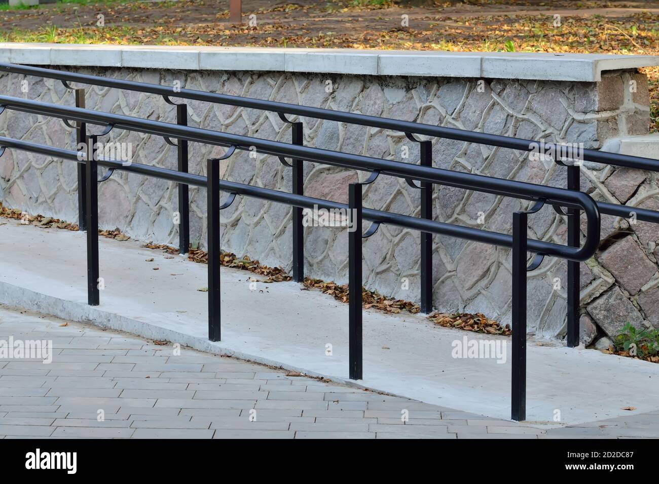 Ramp for wheelchair entry with metal handrails close-up Stock Photo - Alamy