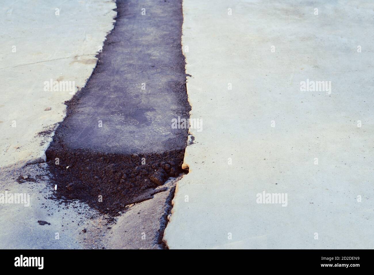 Patch of new asphalt in the old broken road Stock Photo - Alamy