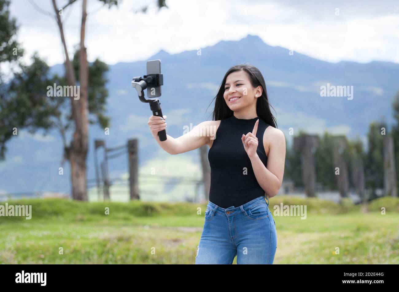 Young Latin blogger doing a live video streaming Stock Photo - Alamy