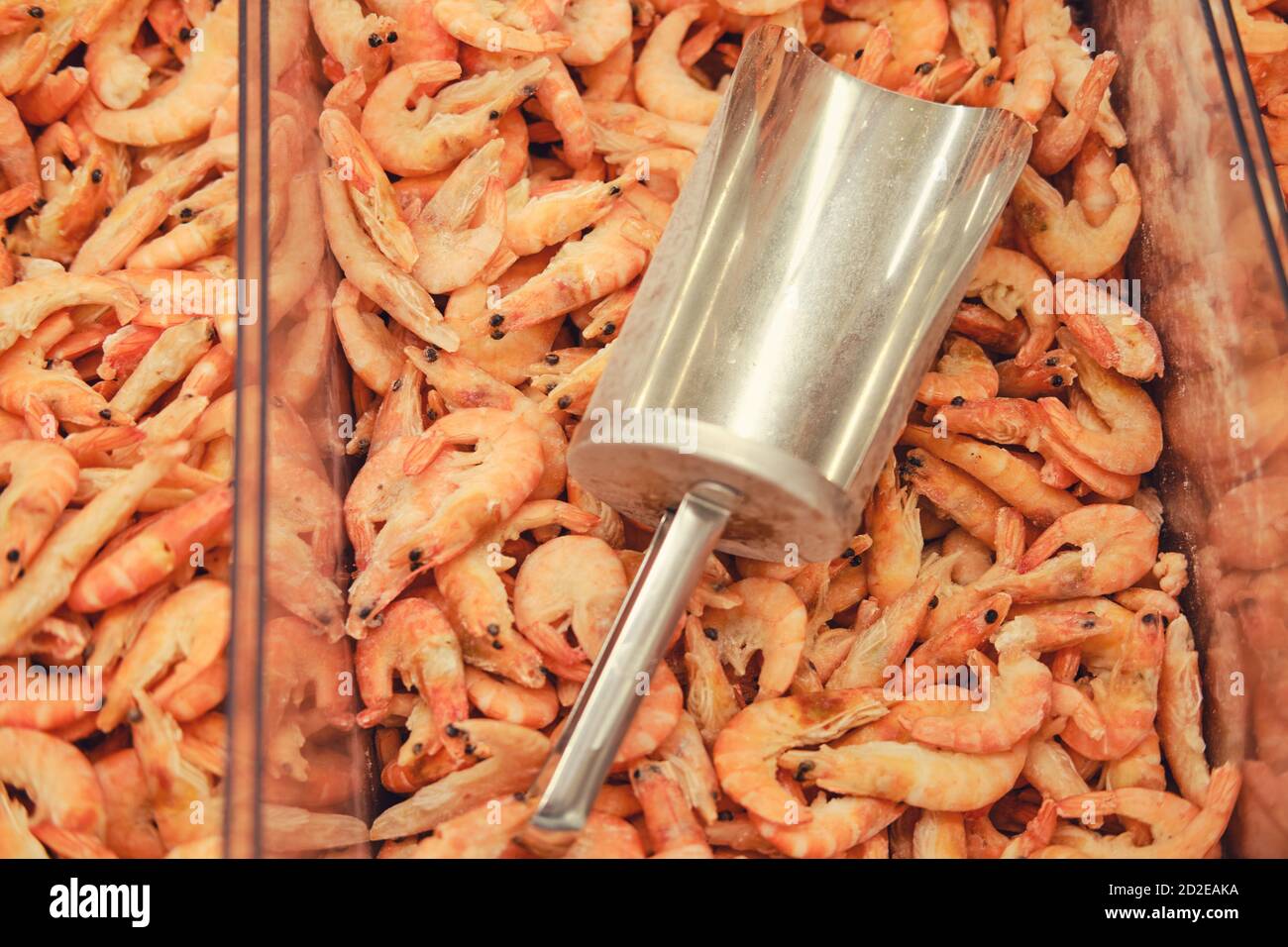 Frozen prawns on the store counter and a metal scoop Stock Photo - Alamy