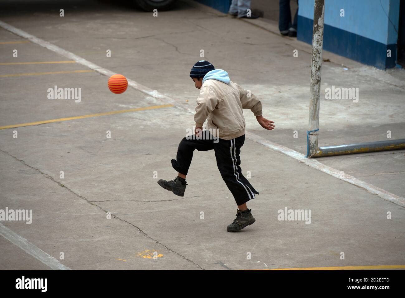 An indigenous Kiche (Quiché) Maya boy playing football (soccer). San ...