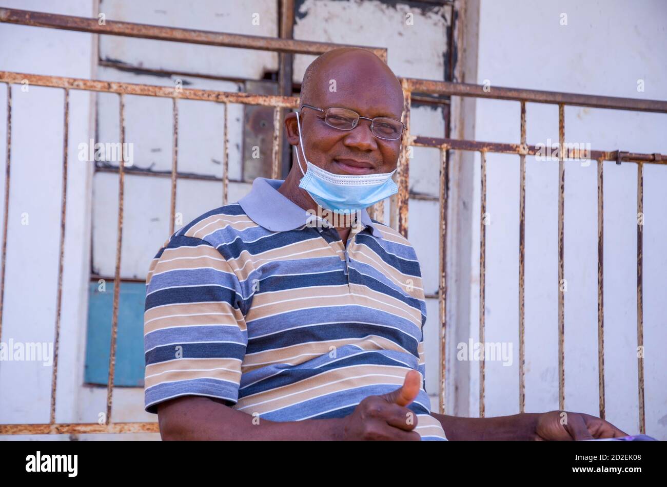aged handsome african man wearing face mask preventing himself from the ...