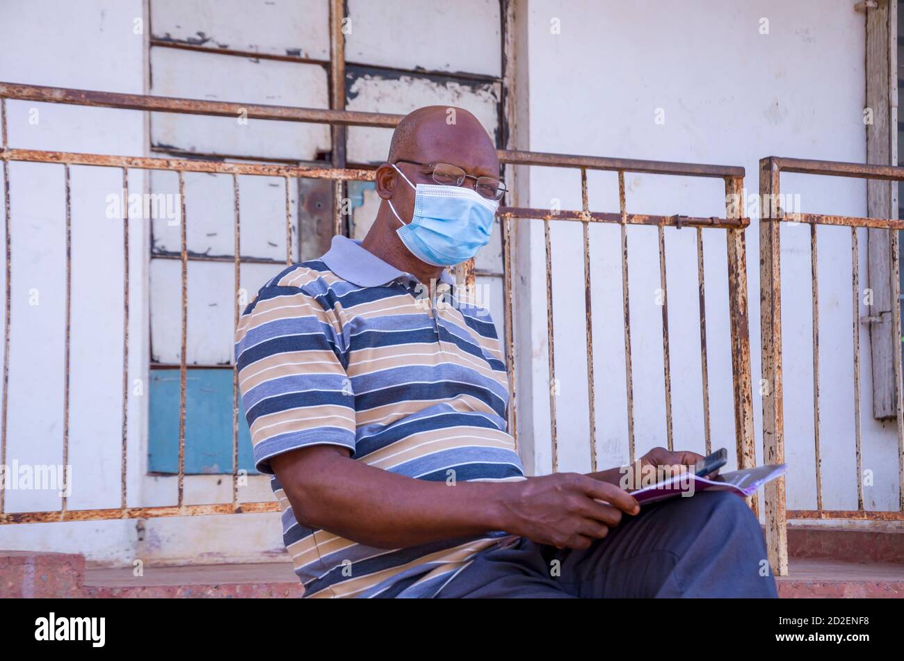 aged handsome african man wearing face mask preventing himself from the ...