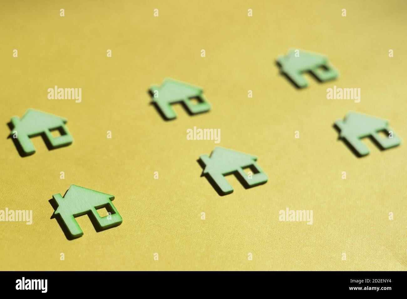mini wooden houses in a green and gold colour scheme Stock Photo - Alamy